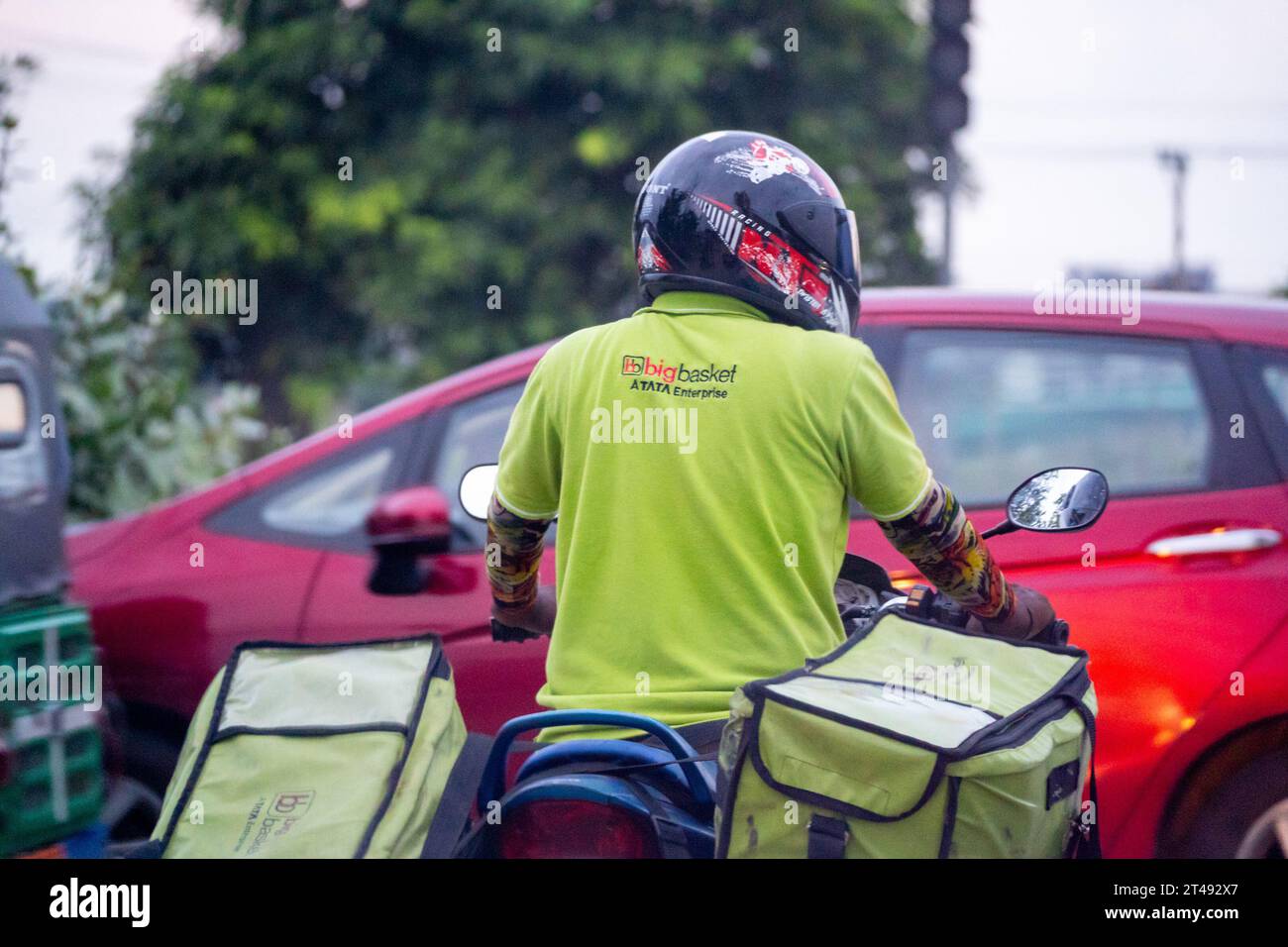 Rider delivery boy agent for Big Basket Tata Group in green uniform and ...