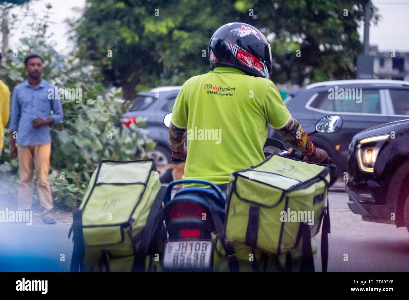 Rider delivery boy agent for Big Basket Tata Group in green uniform and ...