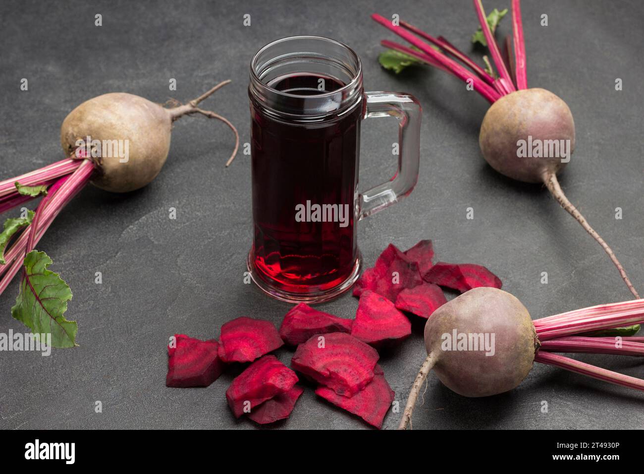 Glass of beetroot juice. Beets with tops, sliced beets. Top view. Black ...