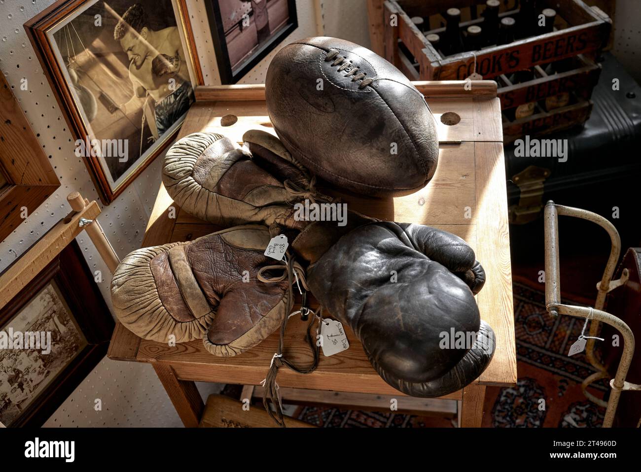 Antique sport equipment of boxing gloves and rugby ball on display at ...