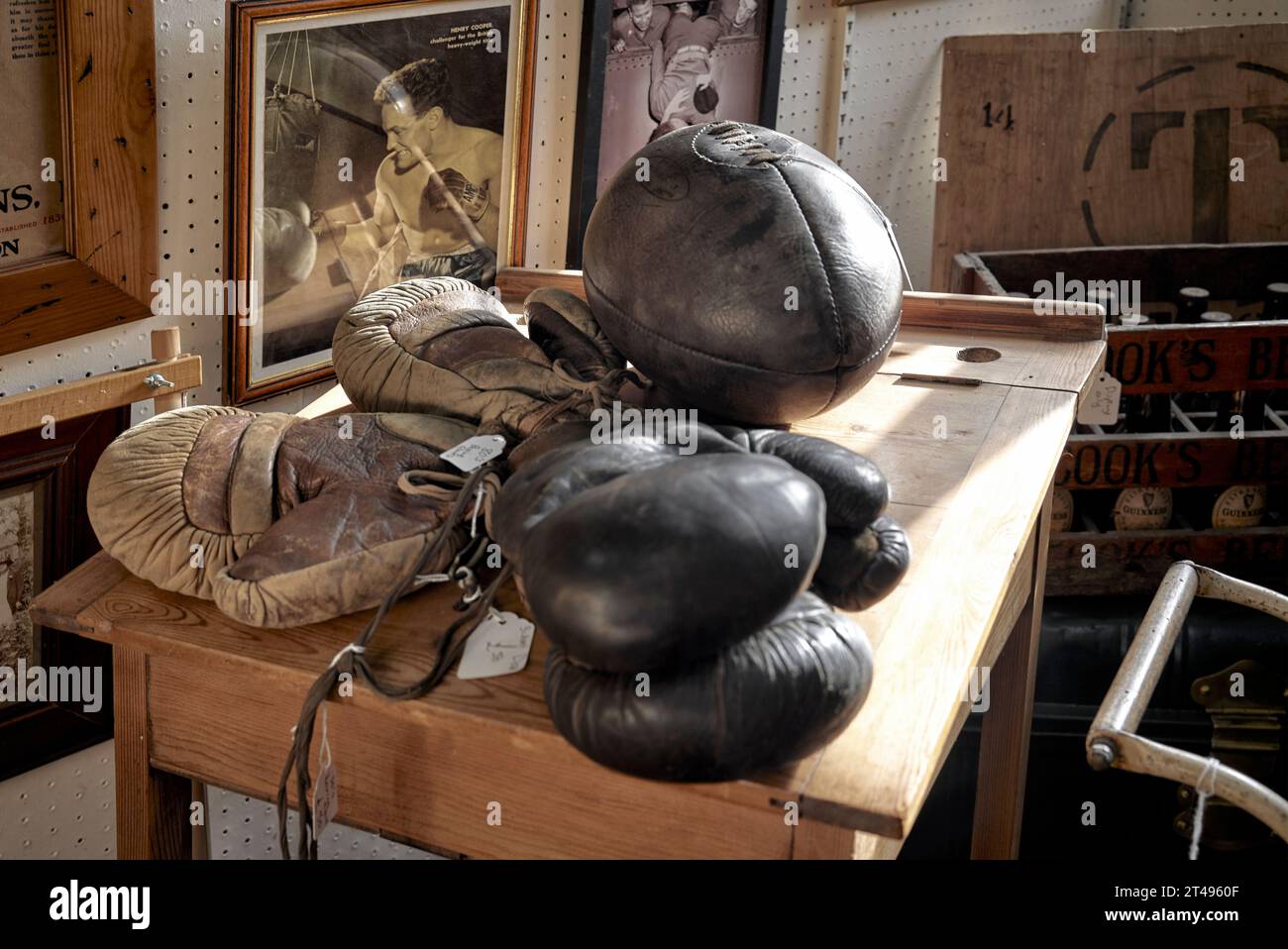 Antique sport equipment of boxing gloves and rugby ball on display at ...