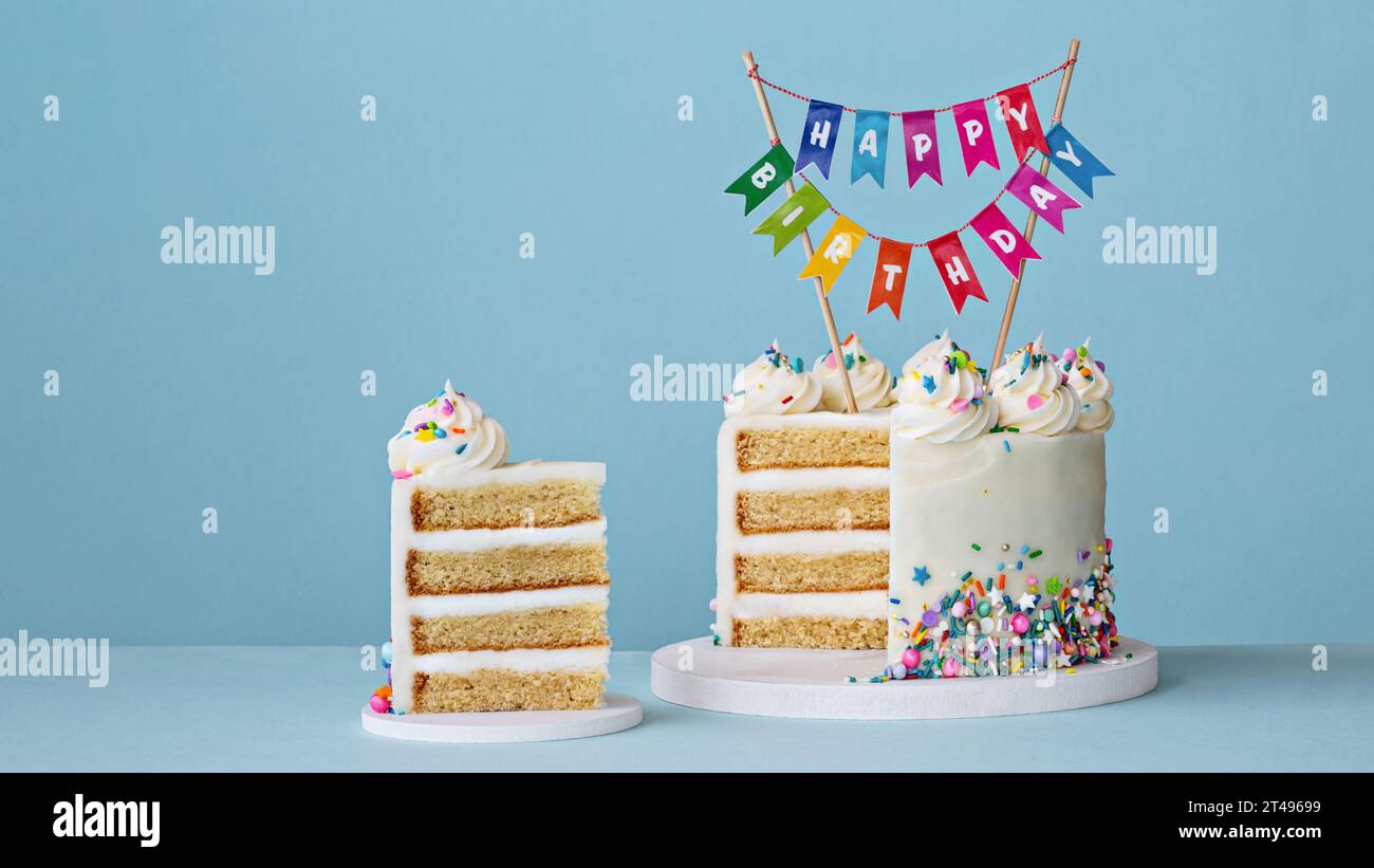 Birthday cake with slice removed and banner reading happy birthday ...
