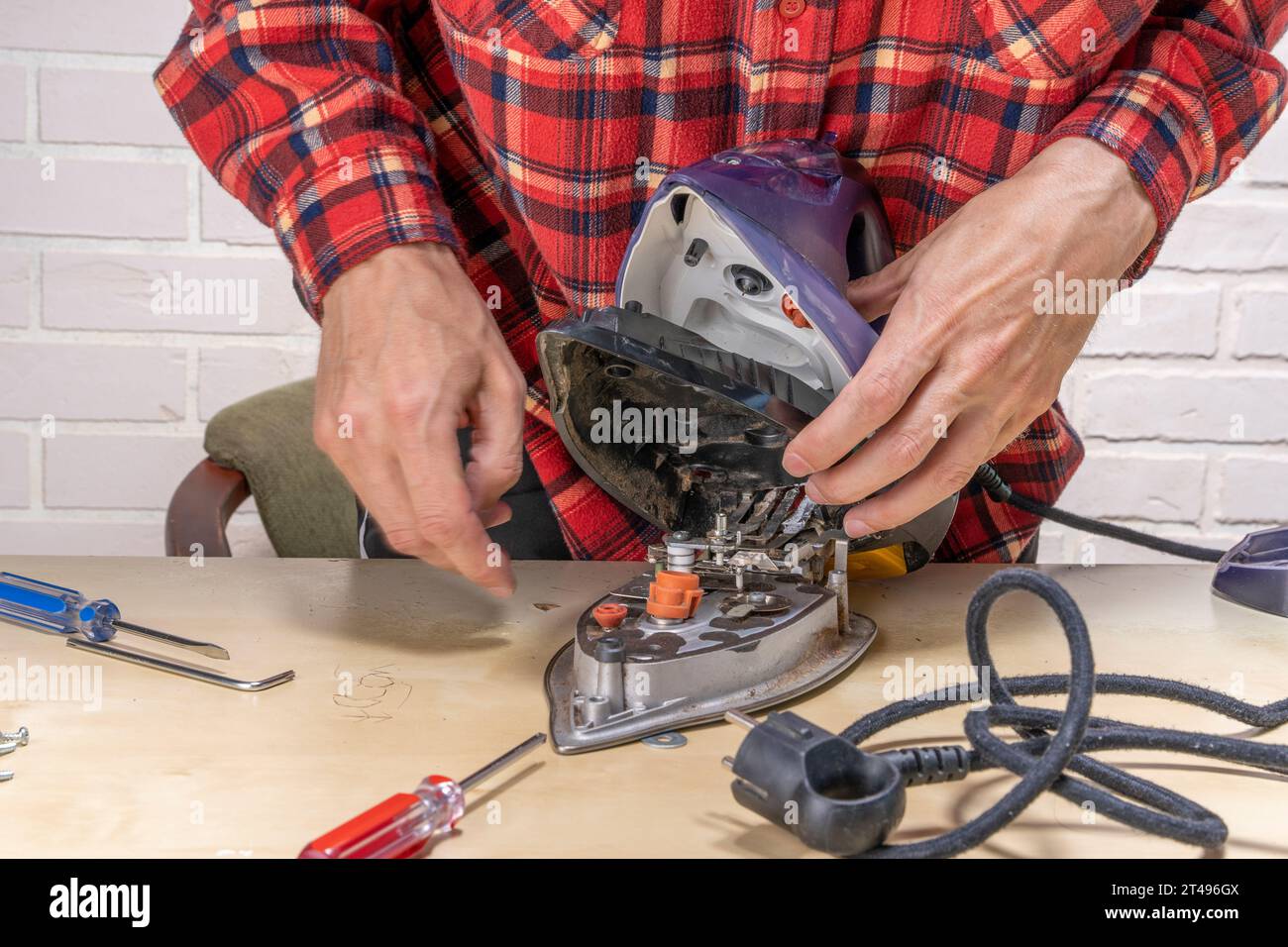 husband or the head of the family is trying to repair a broken steam ...