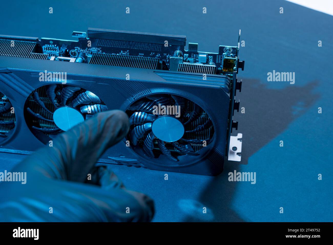 the hand of a computer technician holds a modern powerful video game ...