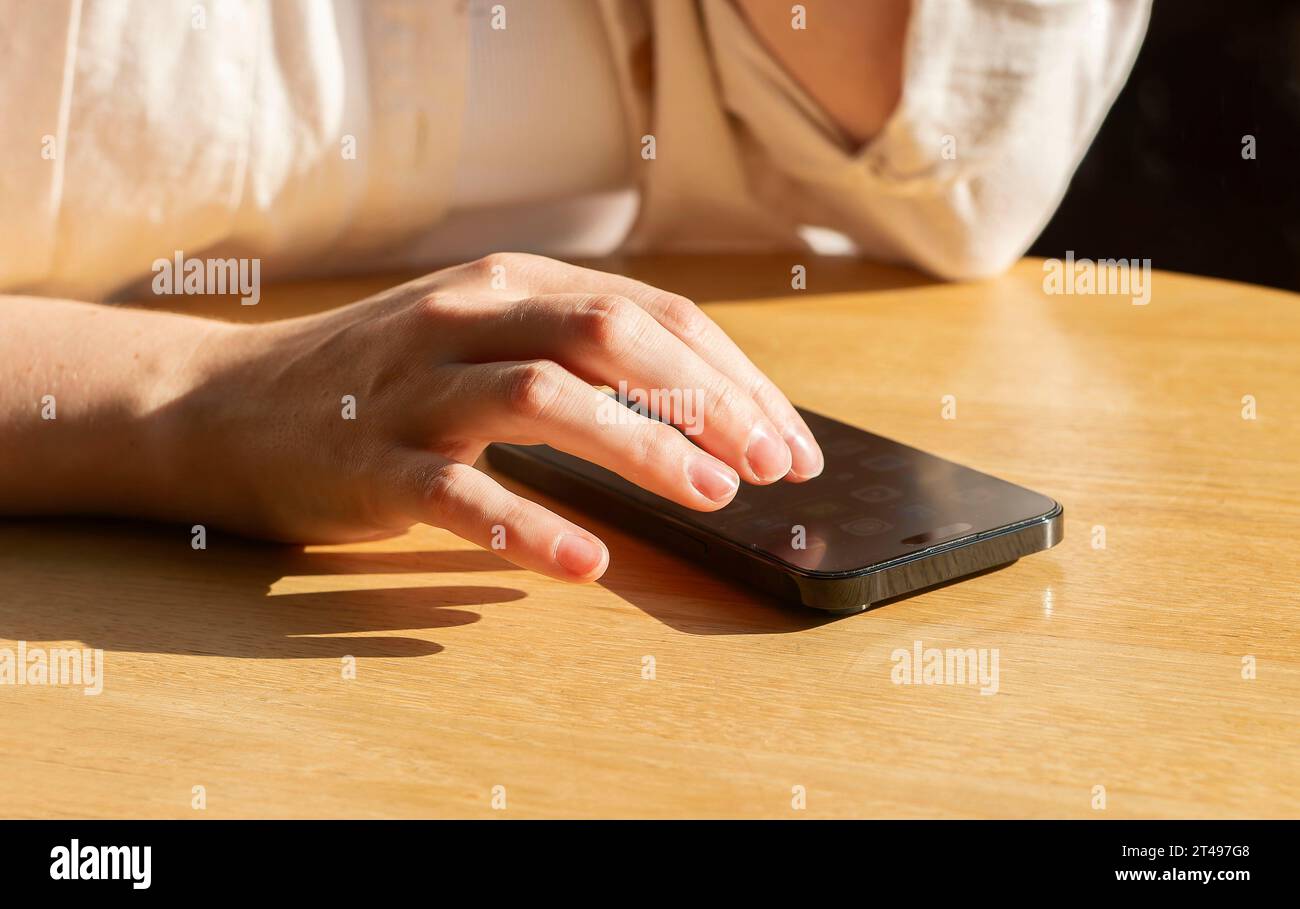 Berlin, Germany October 16 2023 hand with mobile phone, scrolling ...
