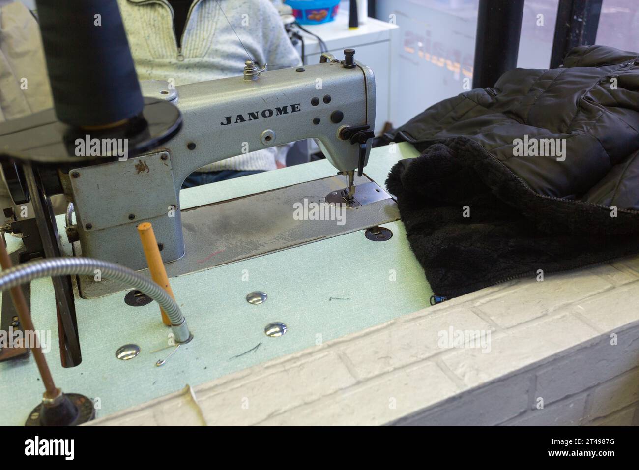 Business - Sewing Machinist at work repairing clothing Stock Photo - Alamy