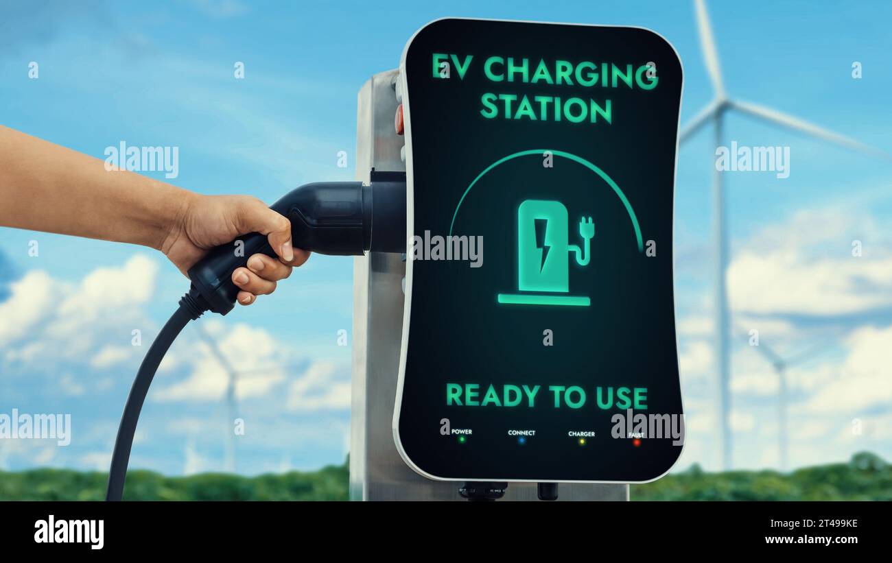 EV charger from EV car charging station in nature and wind turbine farm ...