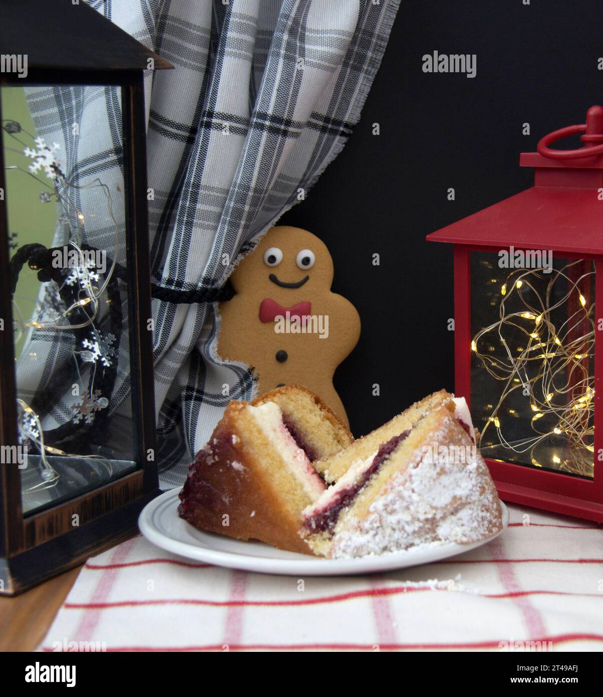 Happy ginger biscuit person finding slices of cream cake behind curtain ...