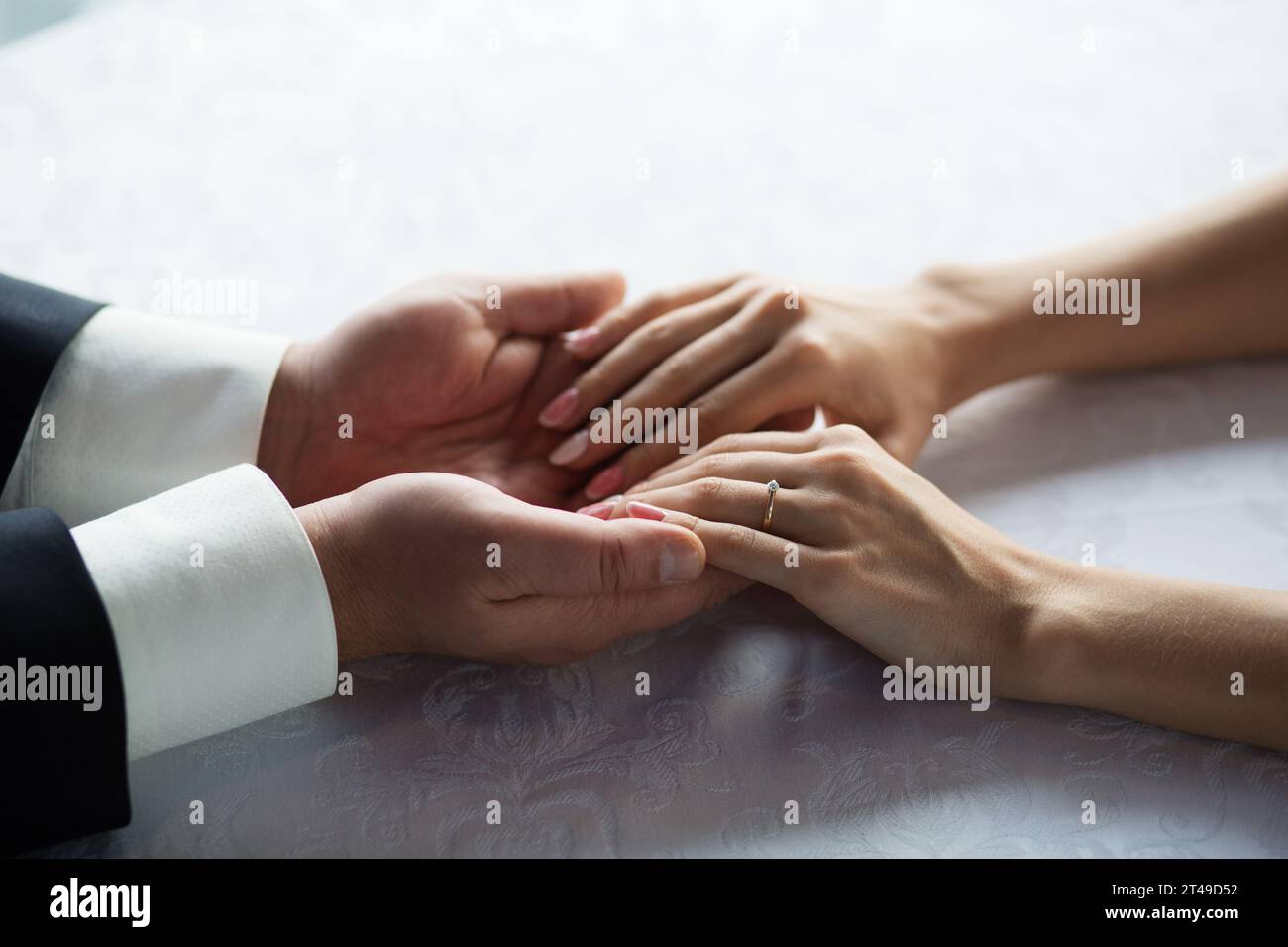 Touching moment showcasing intertwined hands hi-res stock photography ...