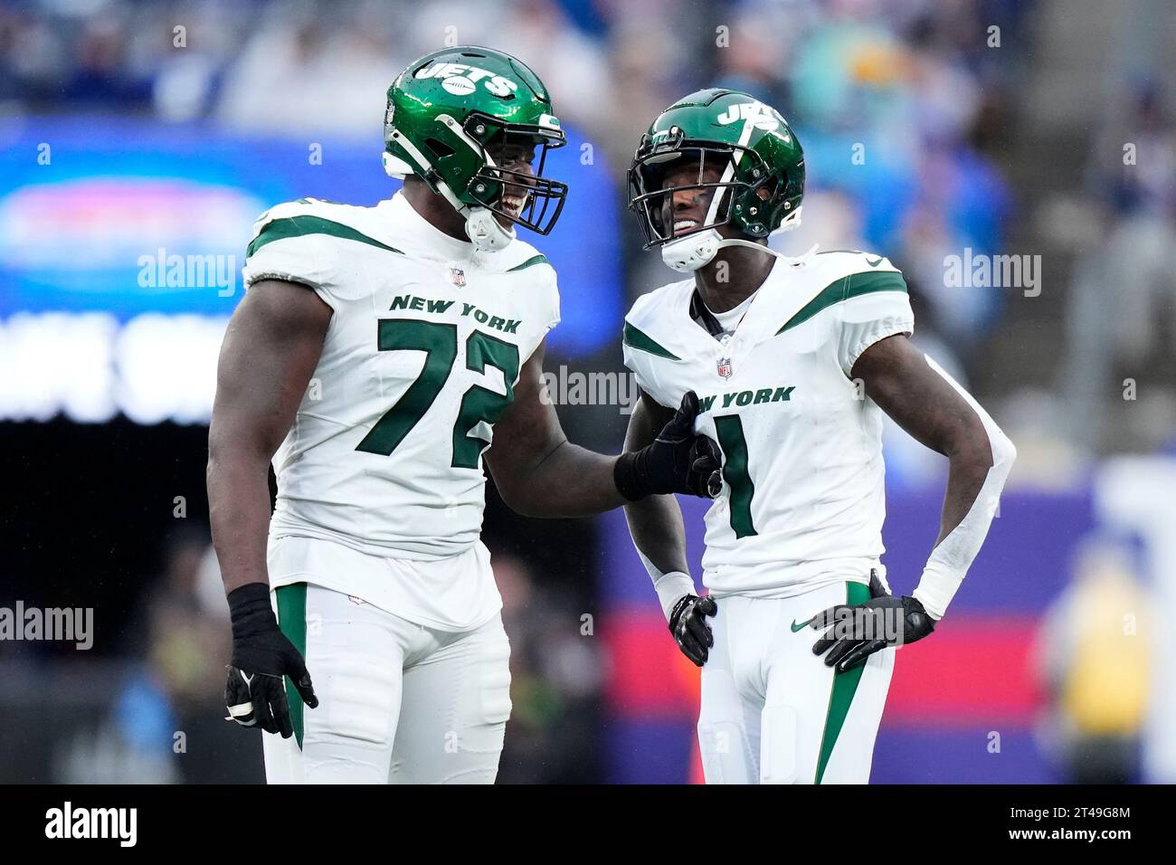 New York Jets defensive lineman Micheal Clemons (72) and cornerback ...