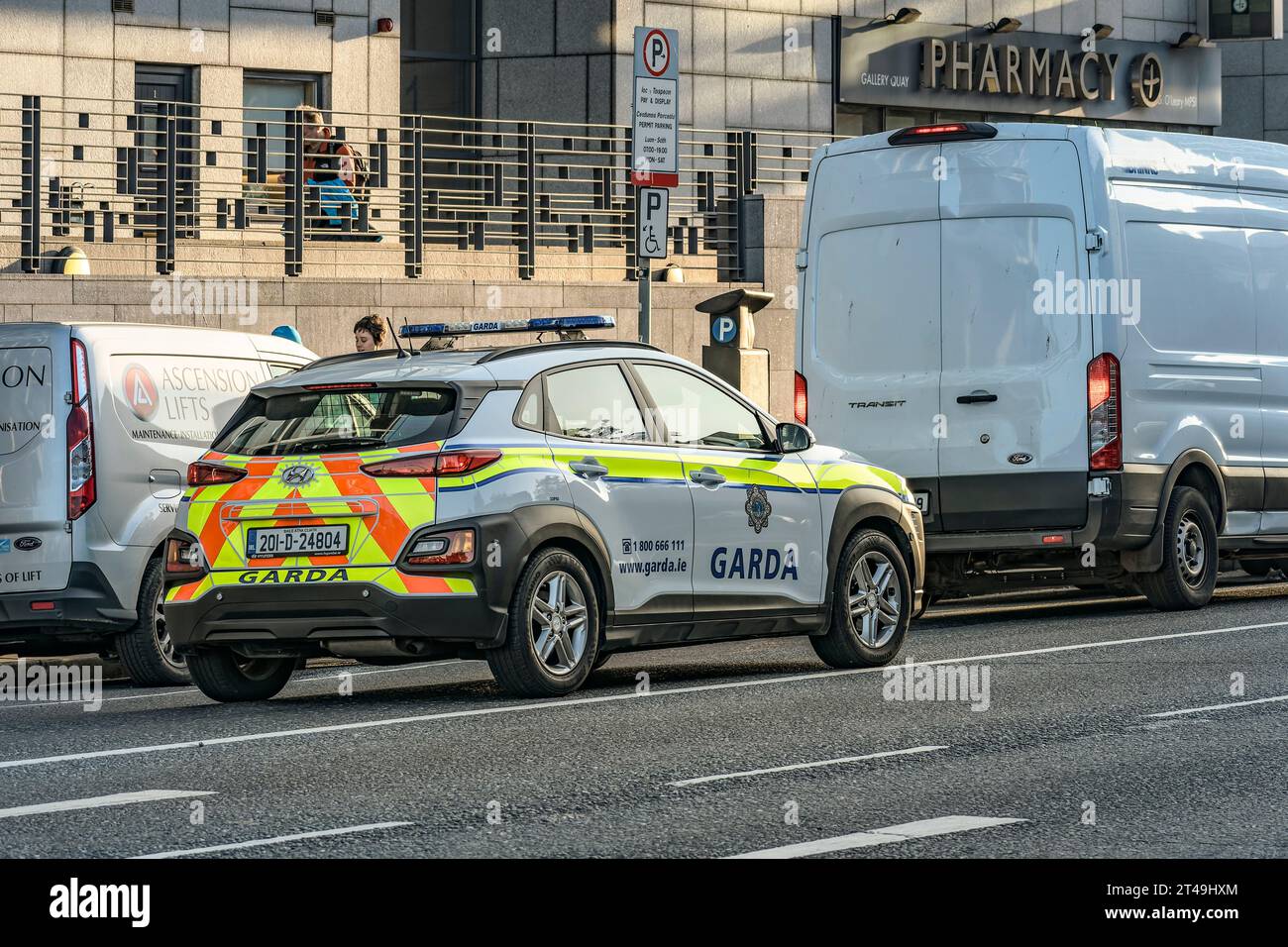 A patrol car of the Irish police, the Garda Síochána, on-duty driving ...