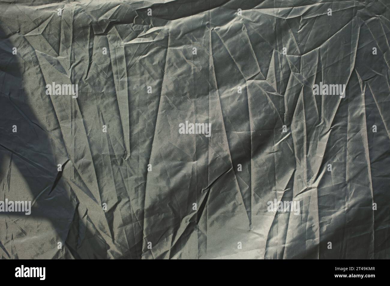 Crumpled fabric of black color. Surface of awning. Wrinkled texture ...
