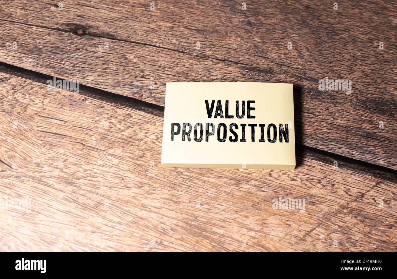 VALUE PROPOSITION text on notebook with pen and pencil on a grey ...