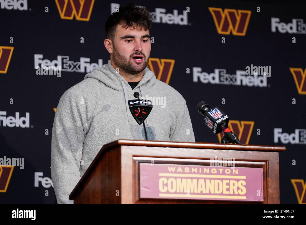Washington Commanders quarterback Sam Howell (14) speaks to members of ...