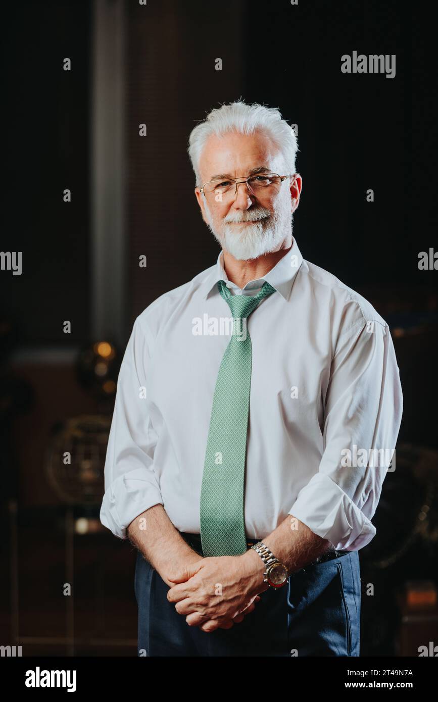 Successful, mature, university rector standing proudly and posing for ...