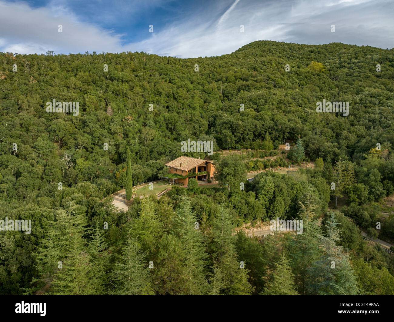 Aerial view of the Can Xisquet rural house, surrounded by forest near ...