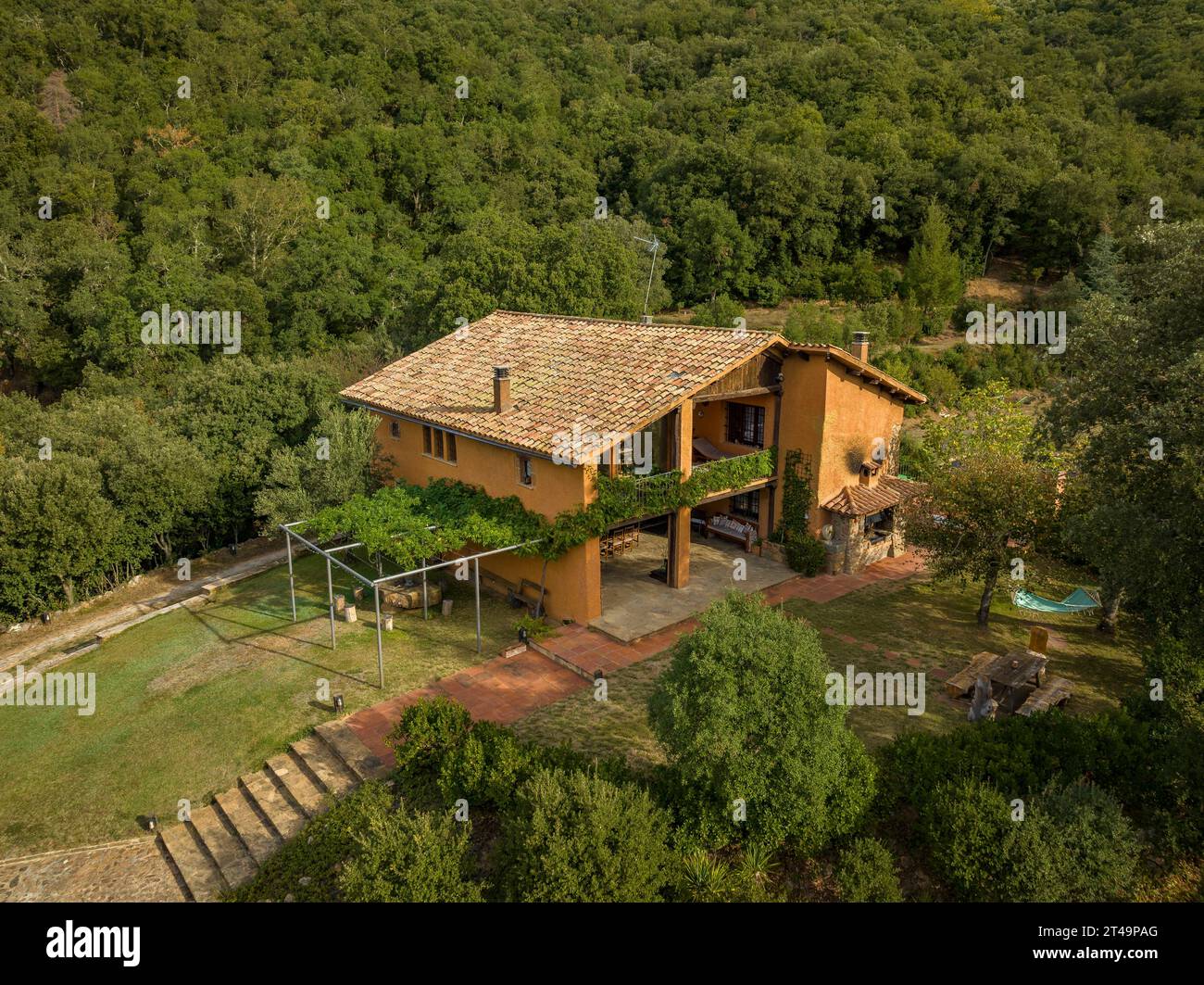 Aerial view of the Can Xisquet rural house, surrounded by forest near ...