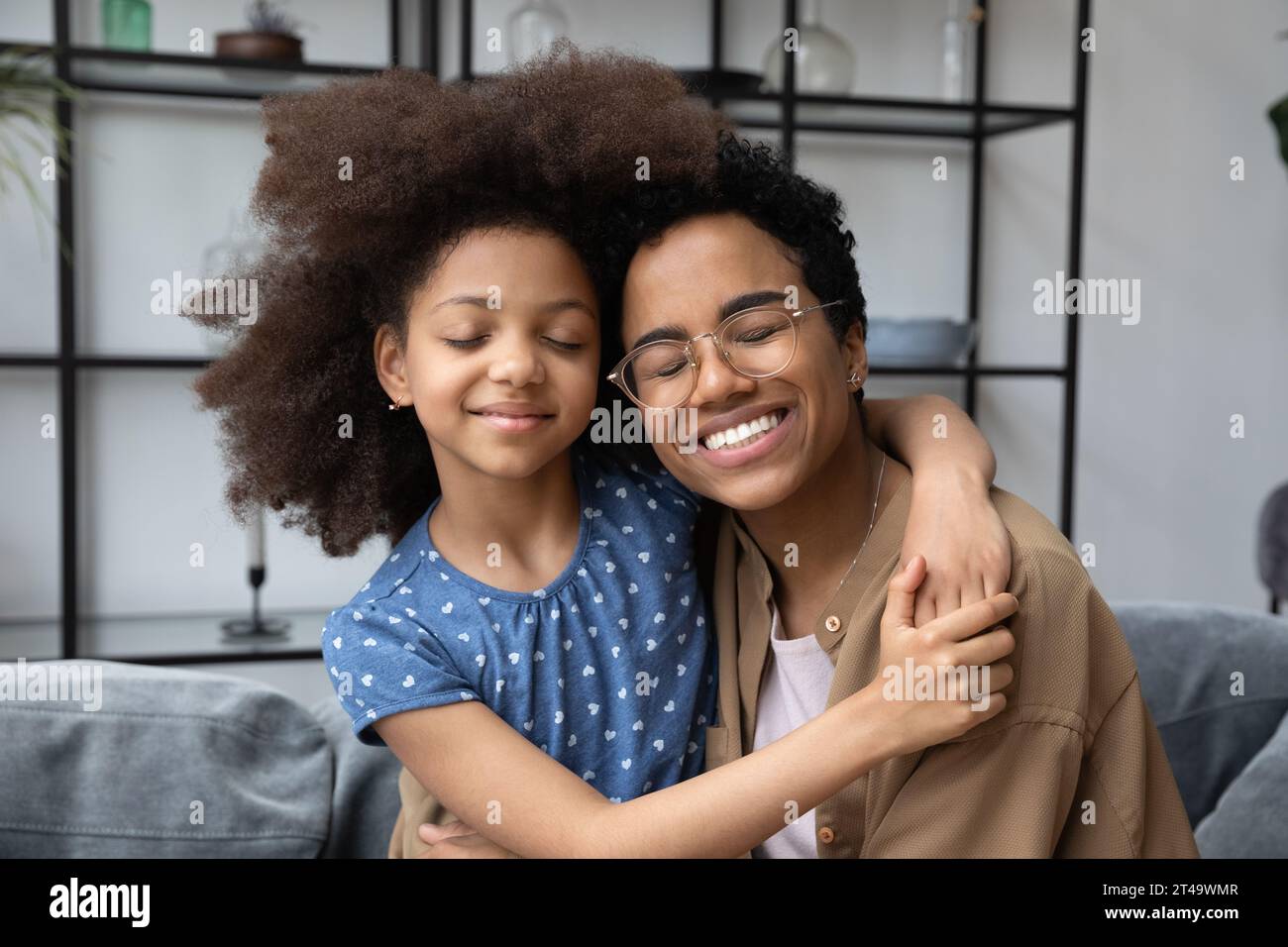 Grateful mother hugging happy pre teen daughter kid Stock Photo - Alamy