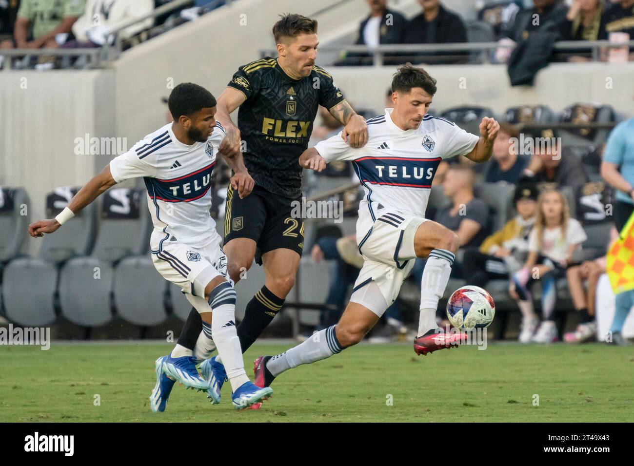 Vancouver Whitecaps midfielder Alessandro Schöpf (8) id defended by LAFC midfielder Ryan ...
