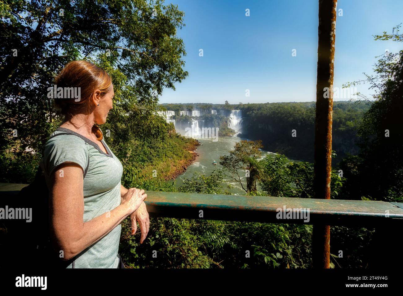 Tourist observes the Iguazu Falls from a viewpoint on the Brazilian ...