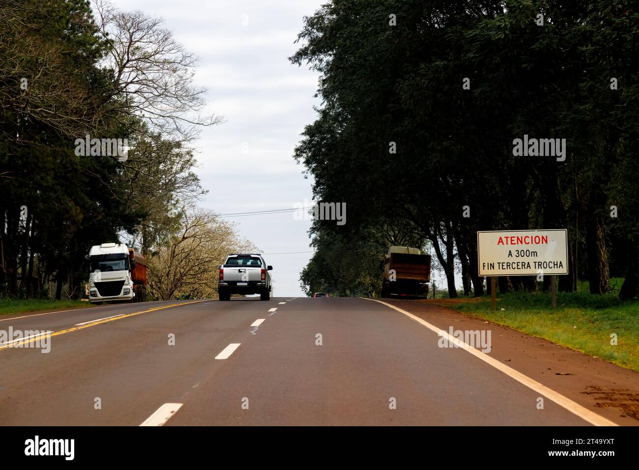 Pickup truck drives along Highway 12 with a sign indicating "Attention ...