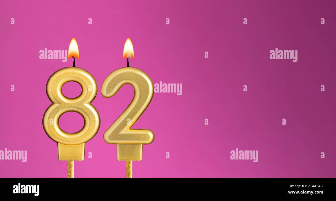 Birthday card with candle number 82 - purple background Stock Photo - Alamy