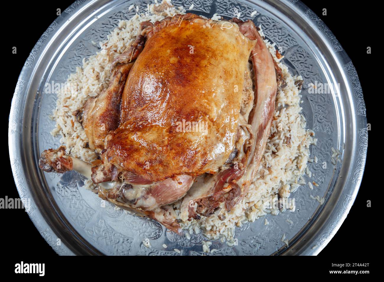 Stuffed lamb ribs. Lamb ribs on rice. Stuffed Ribs isolated on black ...