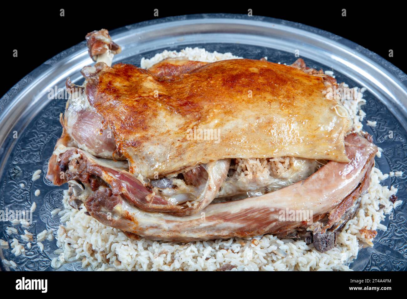 Stuffed lamb ribs. Lamb ribs on rice. Stuffed Ribs isolated on black ...