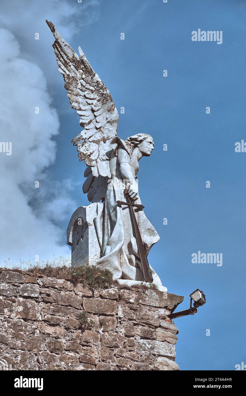 A striking angelic statue guarding in Comillas Cemetery, conveying both ...