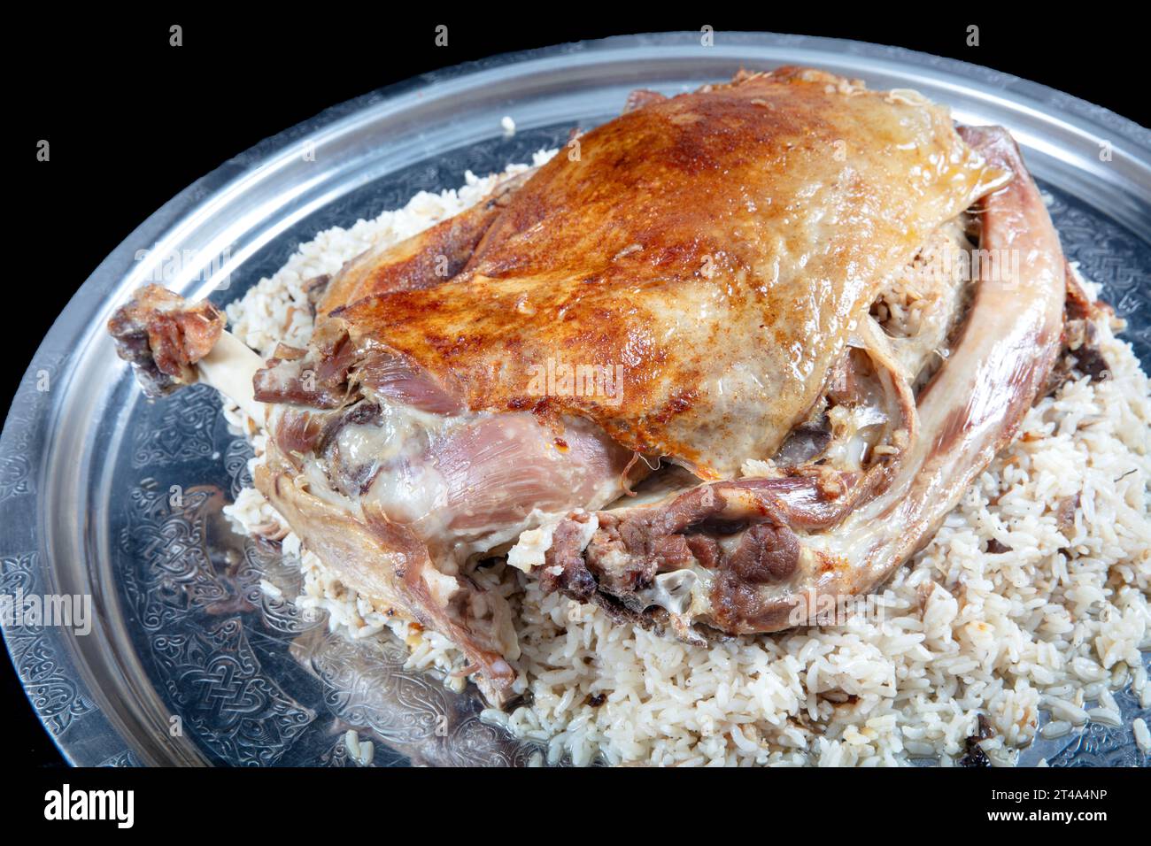 Stuffed lamb ribs. Lamb ribs on rice. Stuffed Ribs isolated on black ...