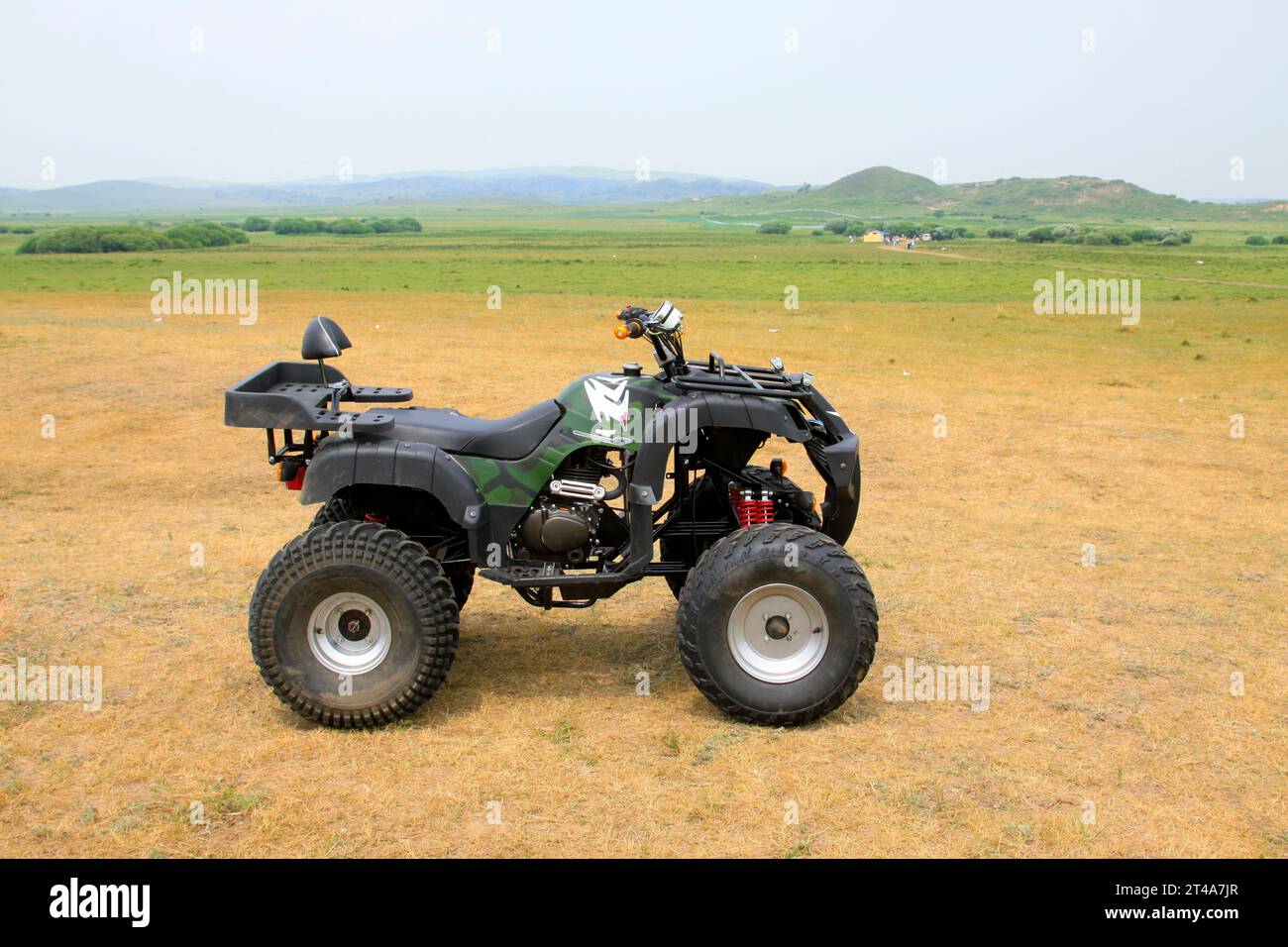 four wheels motorcycle on the grassland, closeup of photo Stock Photo - Alamy