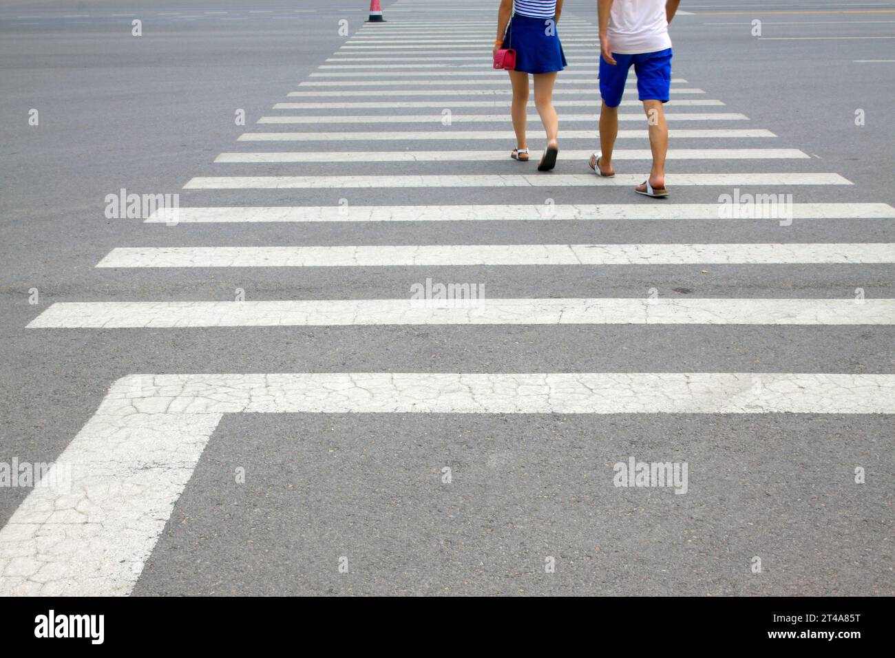 Pedestrians through the zebra crossing Stock Photo - Alamy