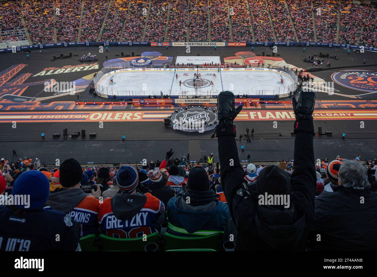 Fans look on as the Calgary Flames and the Edmonton Oilers face off ...
