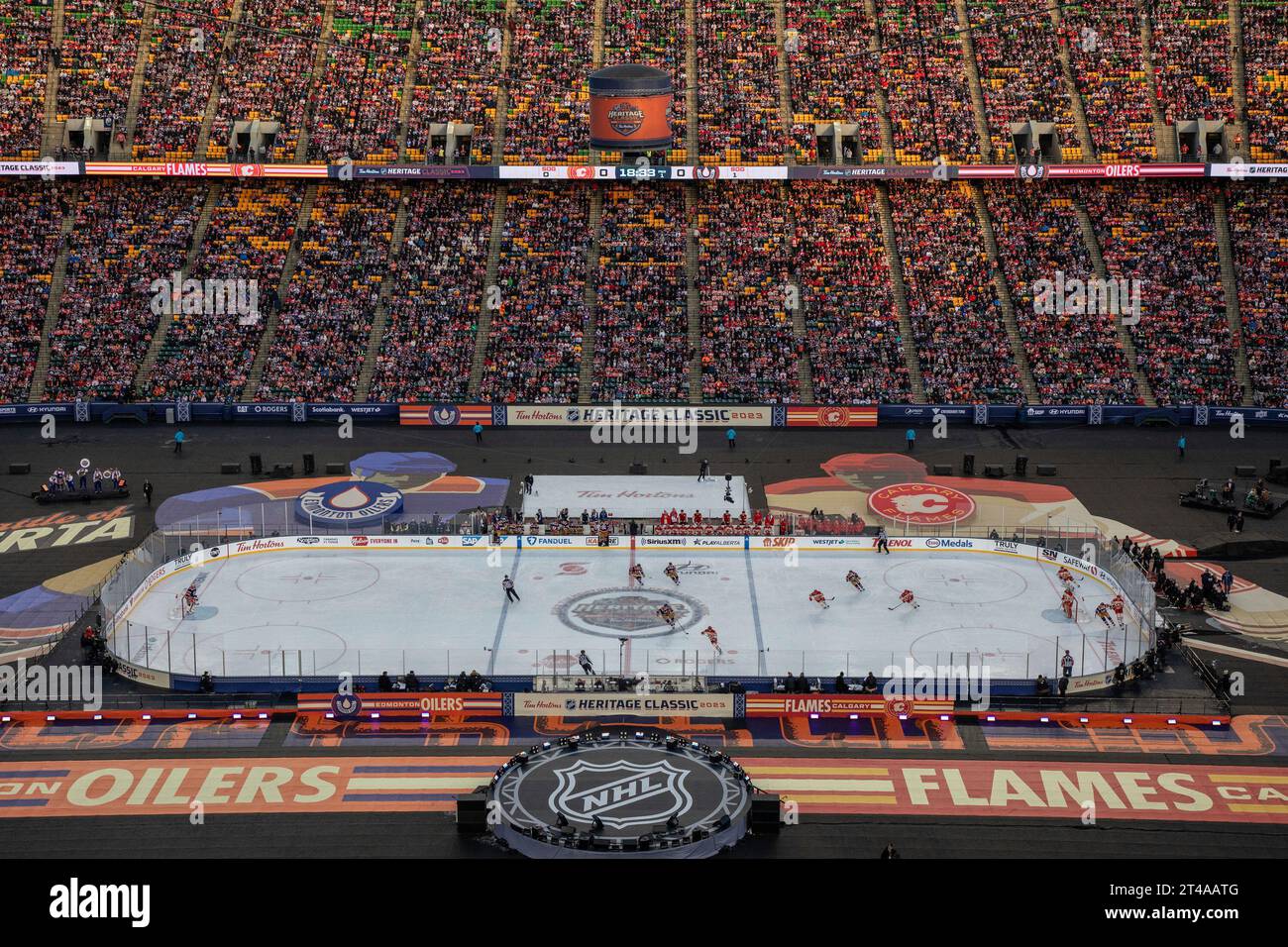 Fans look on as the Calgary Flames and the Edmonton Oilers face off ...