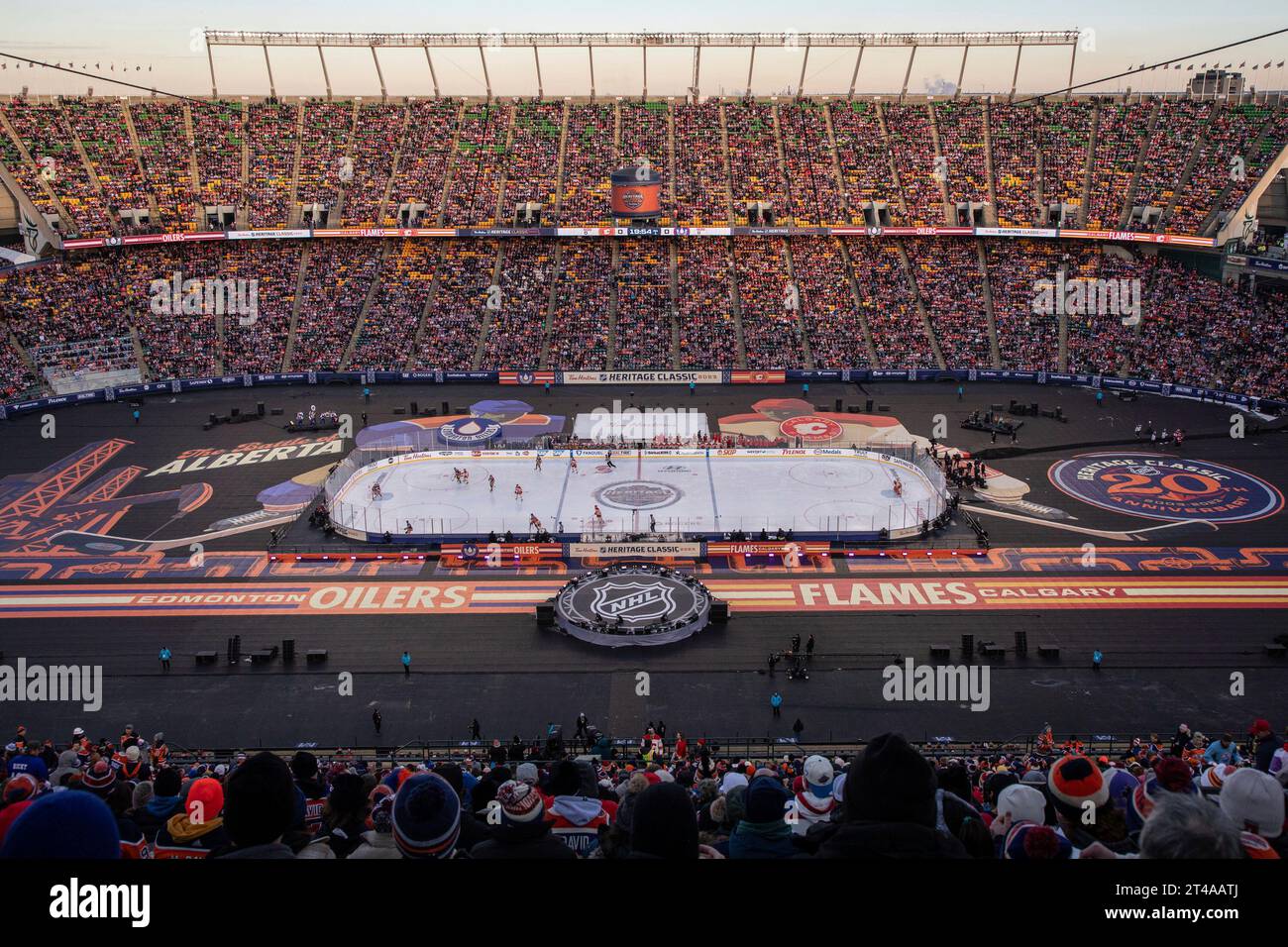 Fans look on as the Calgary Flames and the Edmonton Oilers face off ...