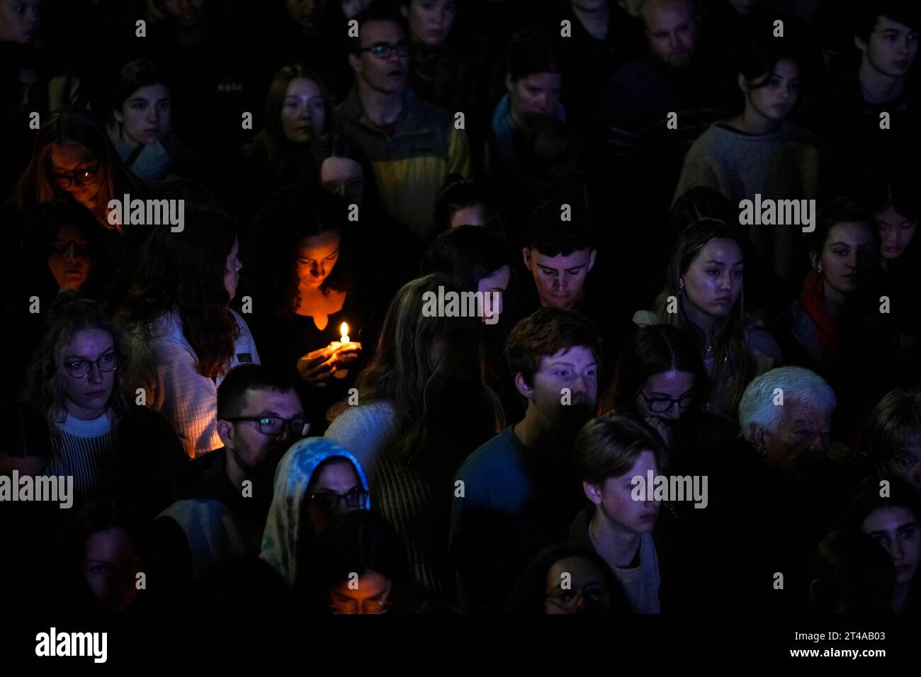 People gather at a vigil for the victims of Wednesday's mass shootings ...