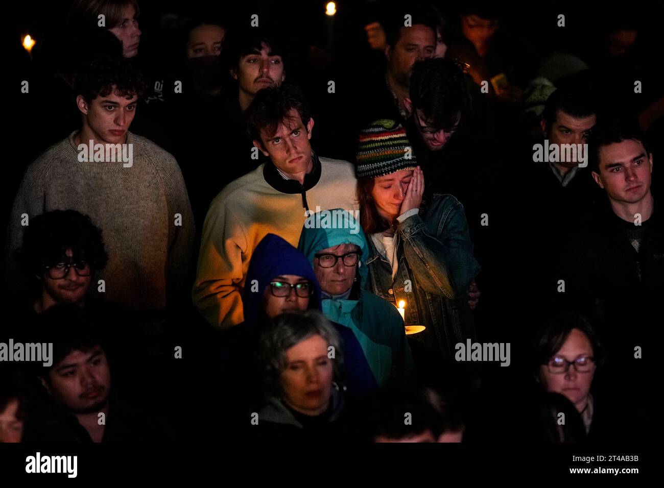 People gather at a vigil for the victims of Wednesday's mass shootings ...