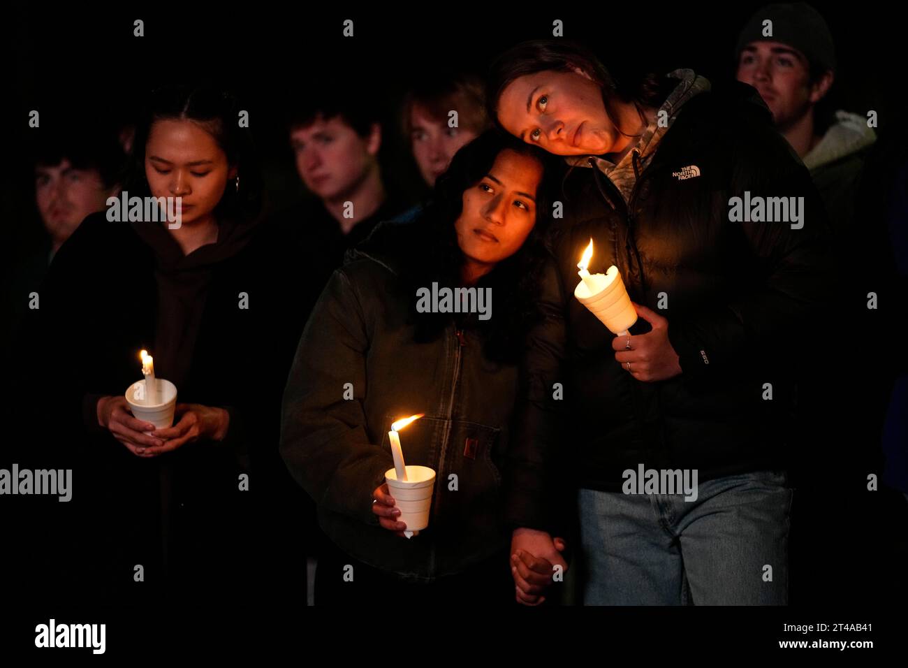 People gather at a vigil for the victims of Wednesday's mass shootings ...