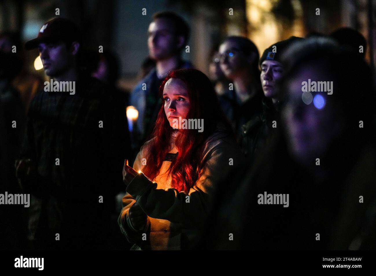 People gather at a vigil for the victims of Wednesday's mass shootings ...