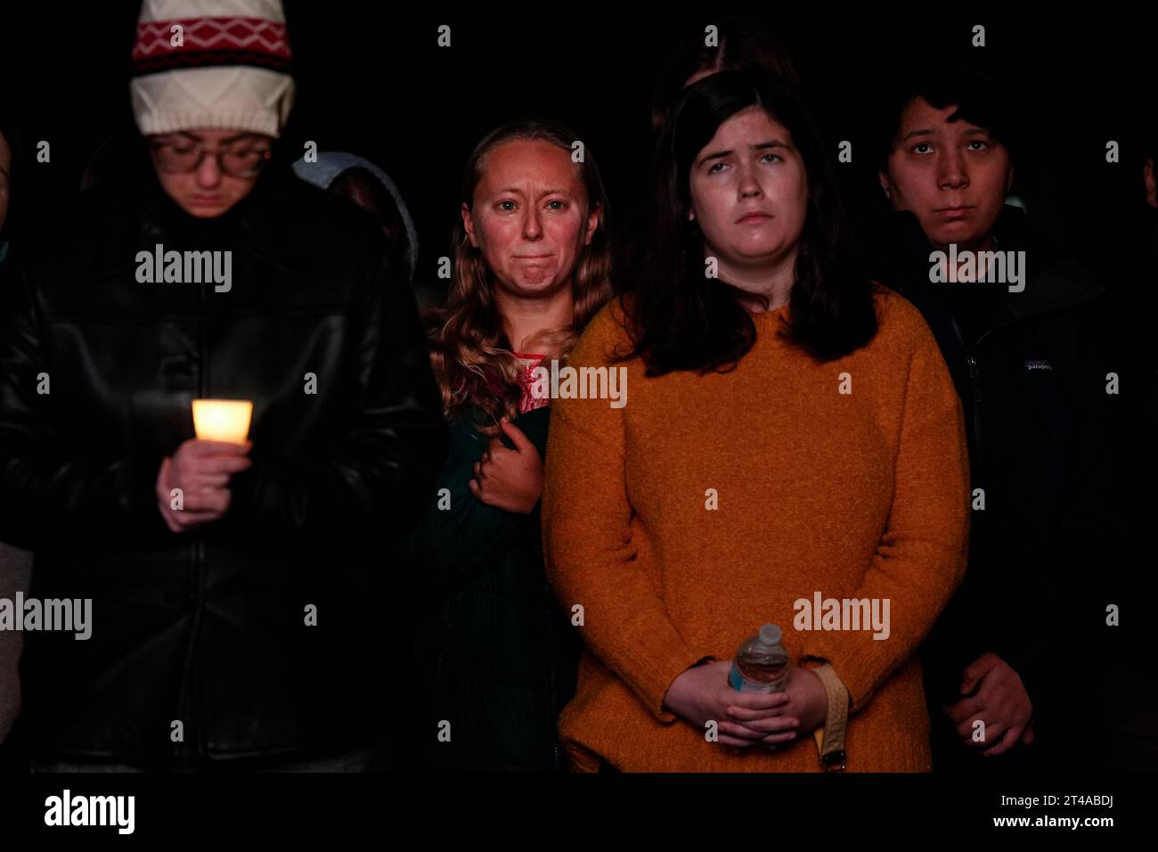 People gather at a vigil for the victims of Wednesday's mass shootings ...