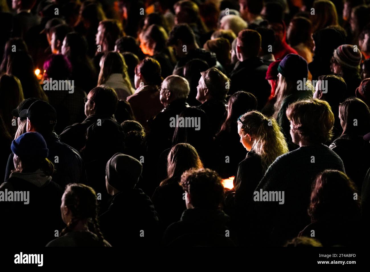 People gather at a vigil for the victims of Wednesday's mass shootings ...