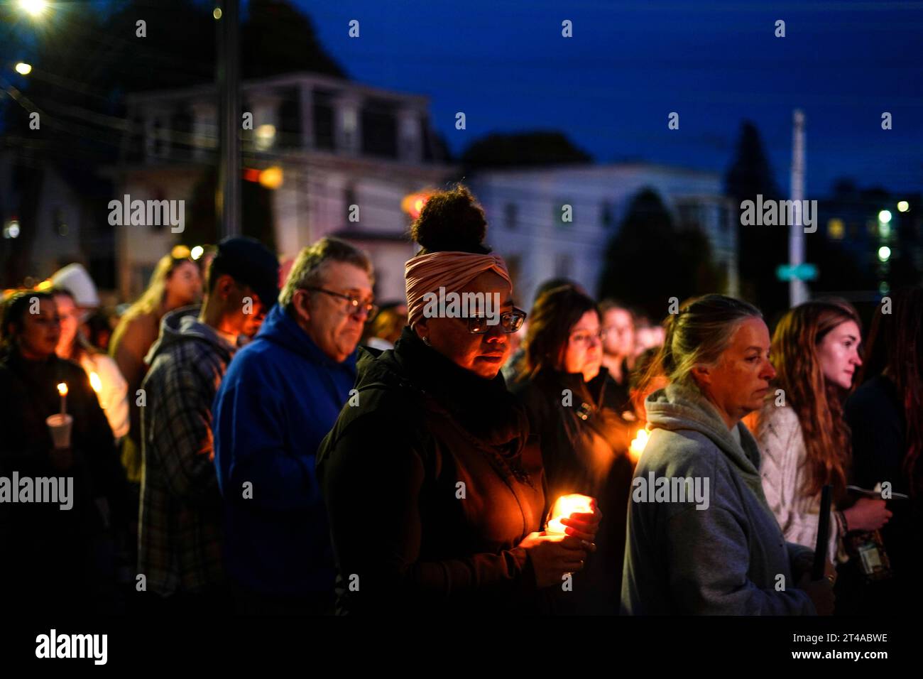 People gather at a vigil for the victims of Wednesday's mass shootings ...