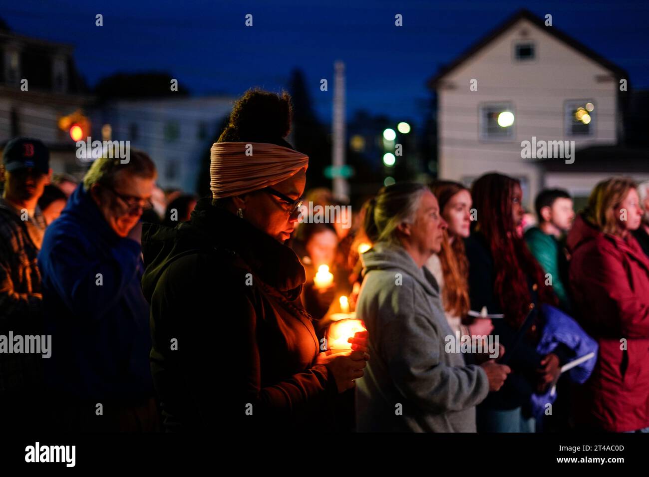 People gather at a vigil for the victims of Wednesday's mass shootings ...