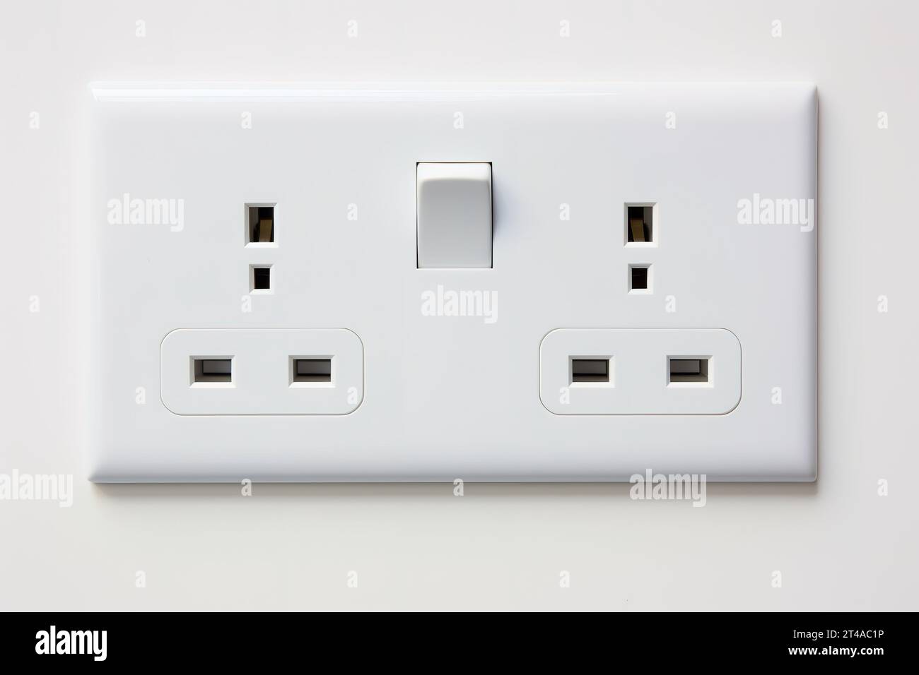 White wall mounted socket board with two electrical sockets and a ...