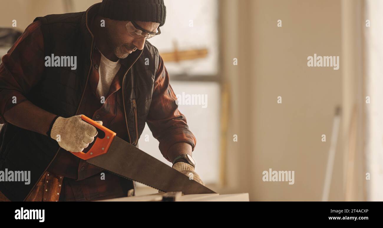 DIY carpenter working indoors on his home renovation project. Using a ...