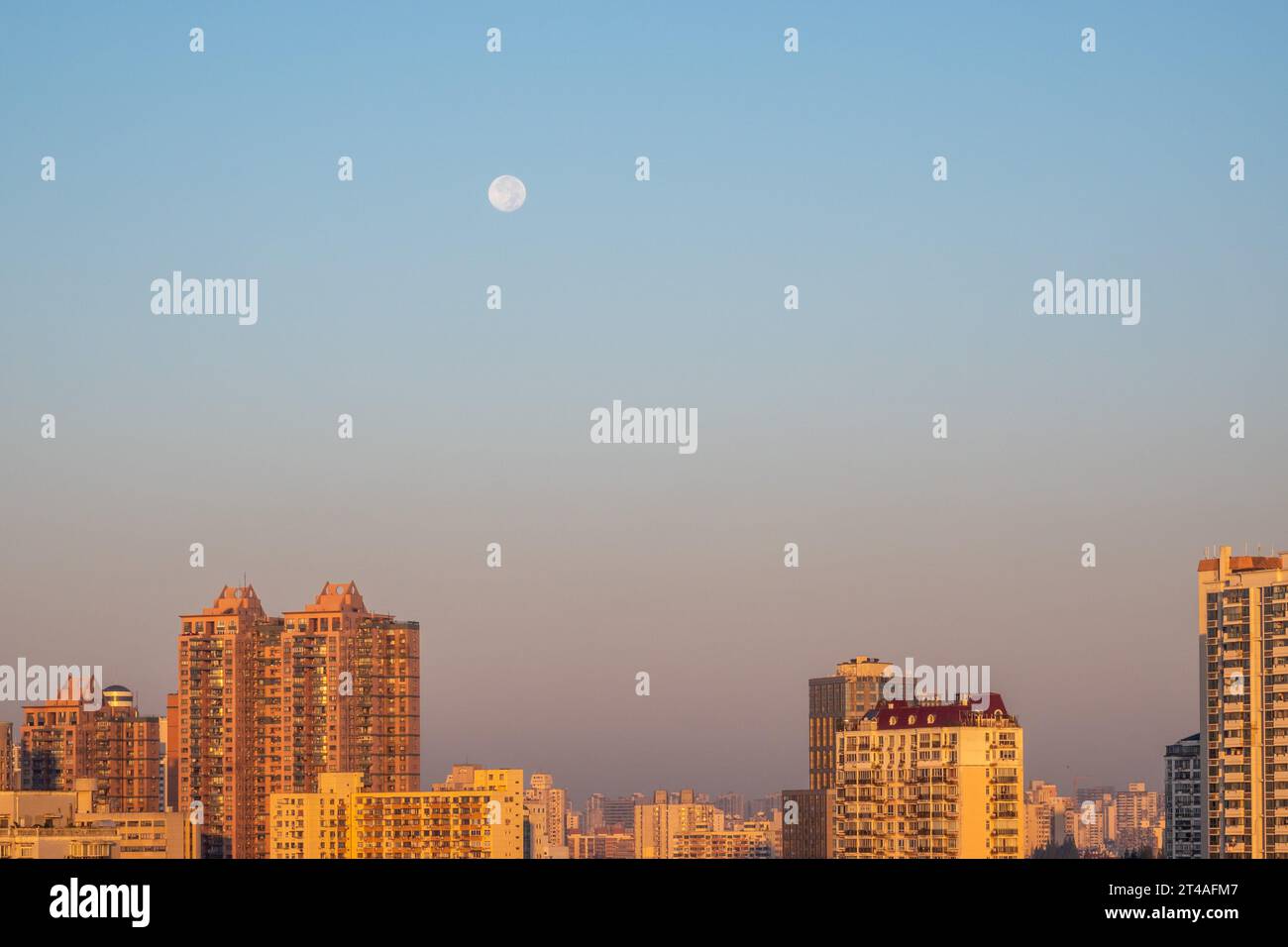 SHANGHAI, CHINA - OCTOBER 30, 2023 - A bright moon slowly descends from ...