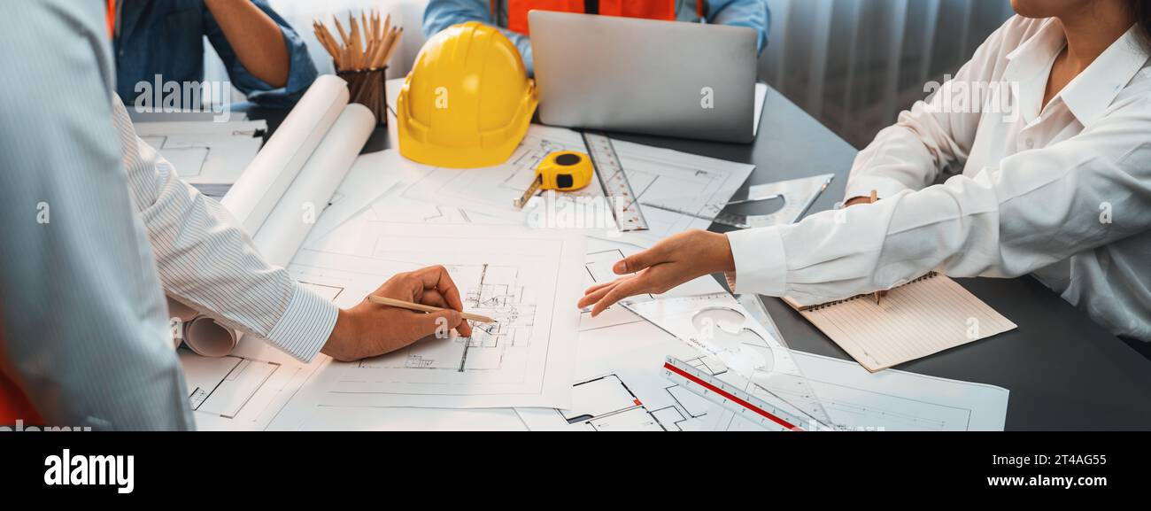 Engineer partner drawing and working on blueprint design together on ...