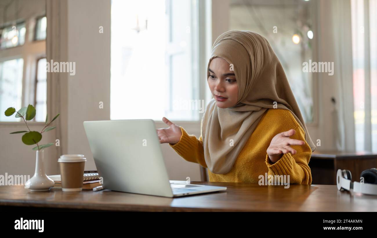 A professional and strict Asian-Muslim businesswoman is shrugging her ...