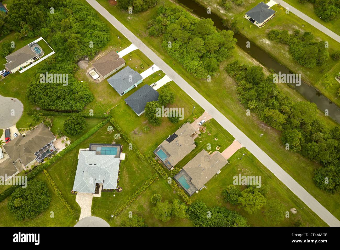 Aerial landscape view of suburban private houses between green palm ...