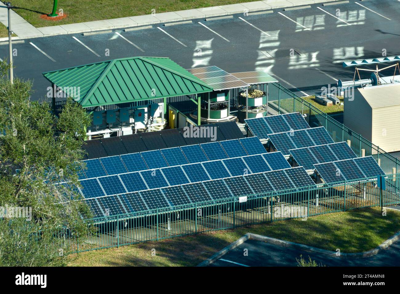 Aerial view of blue solar photovoltaic panels mounted on fenced ...